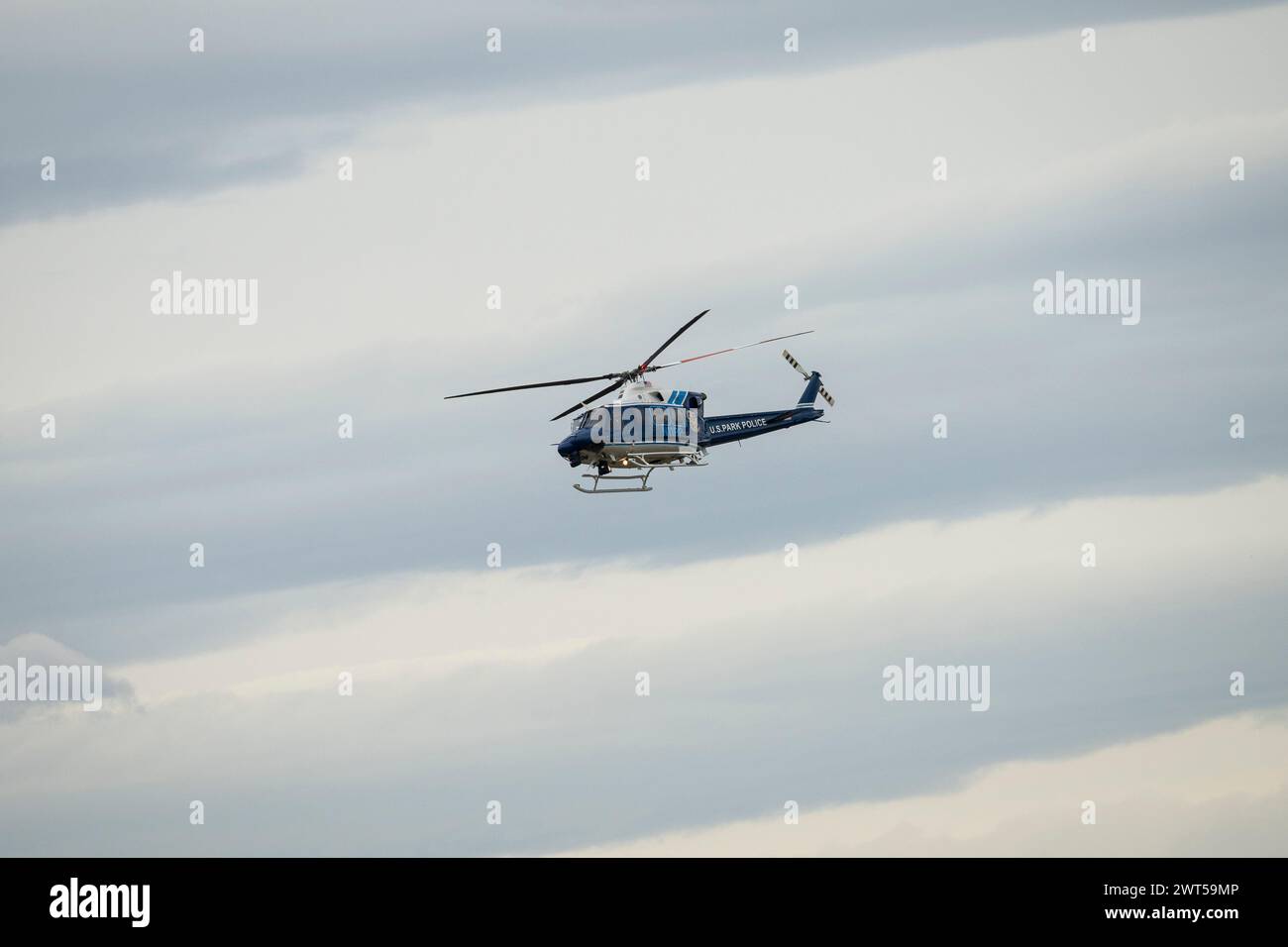 Washington, USA. 15th Mar, 2024. A U.S. Park Police helicopter flies ...