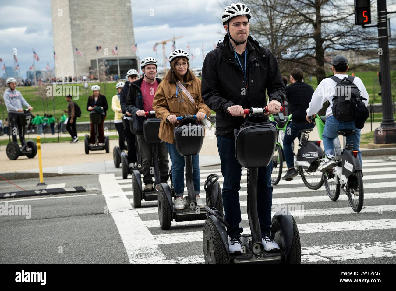 Washington, USA. 15th Mar, 2024. A group Segway tour is seen crossing a ...