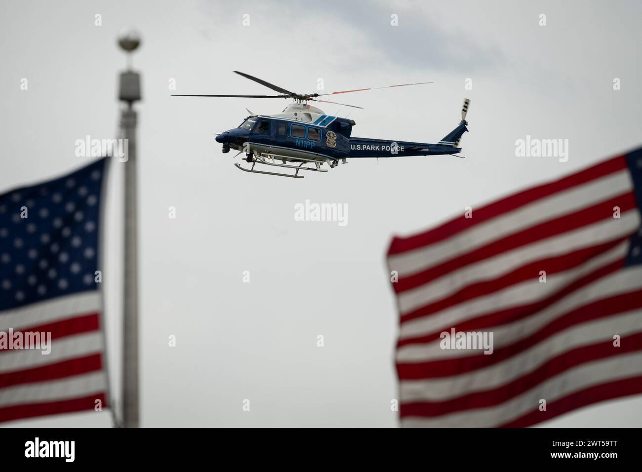 Washington, USA. 15th Mar, 2024. A U.S. Park Police helicopter flies ...