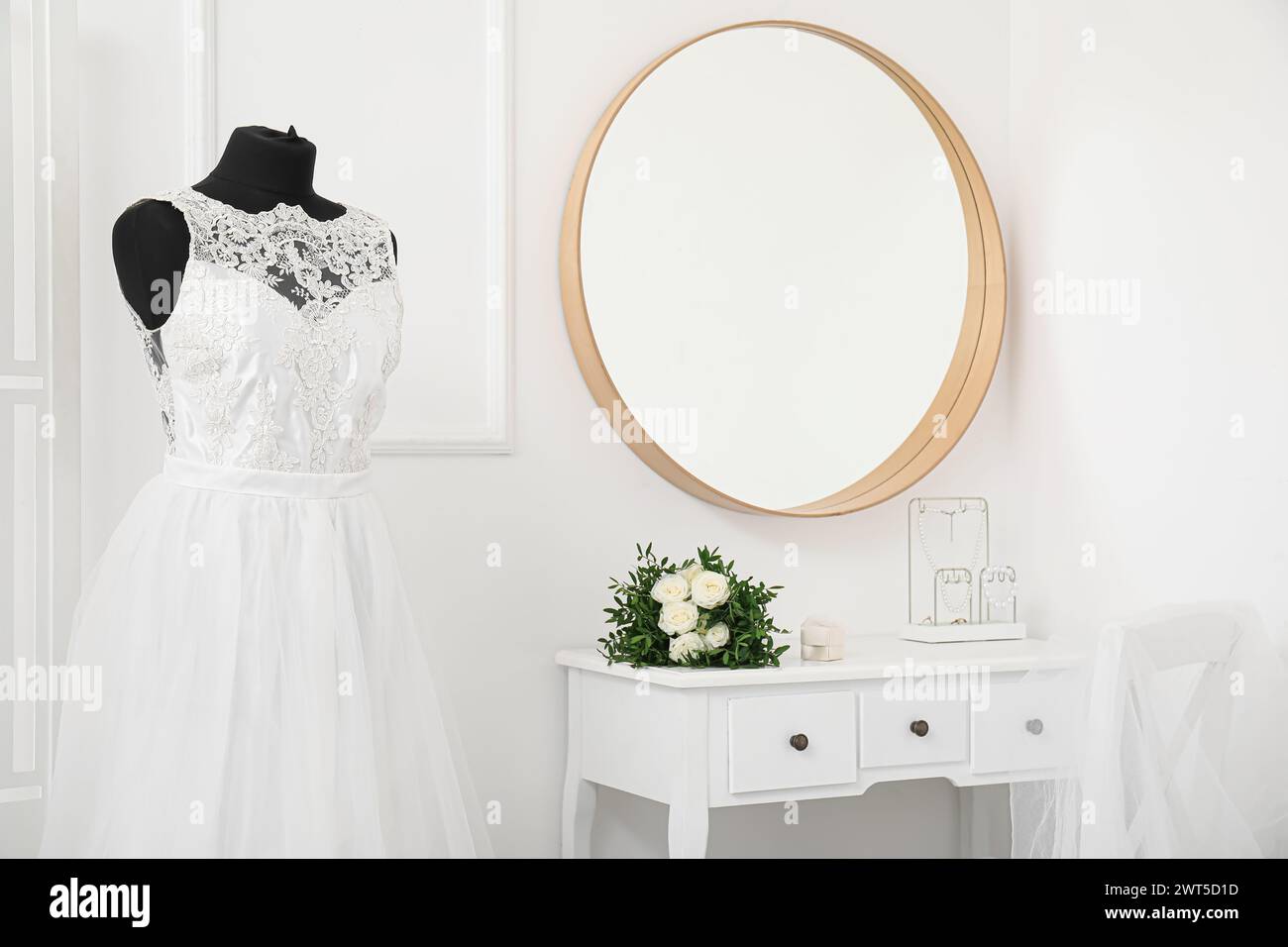 Mannequin with wedding dress and wedding bouquet on white dressing ...