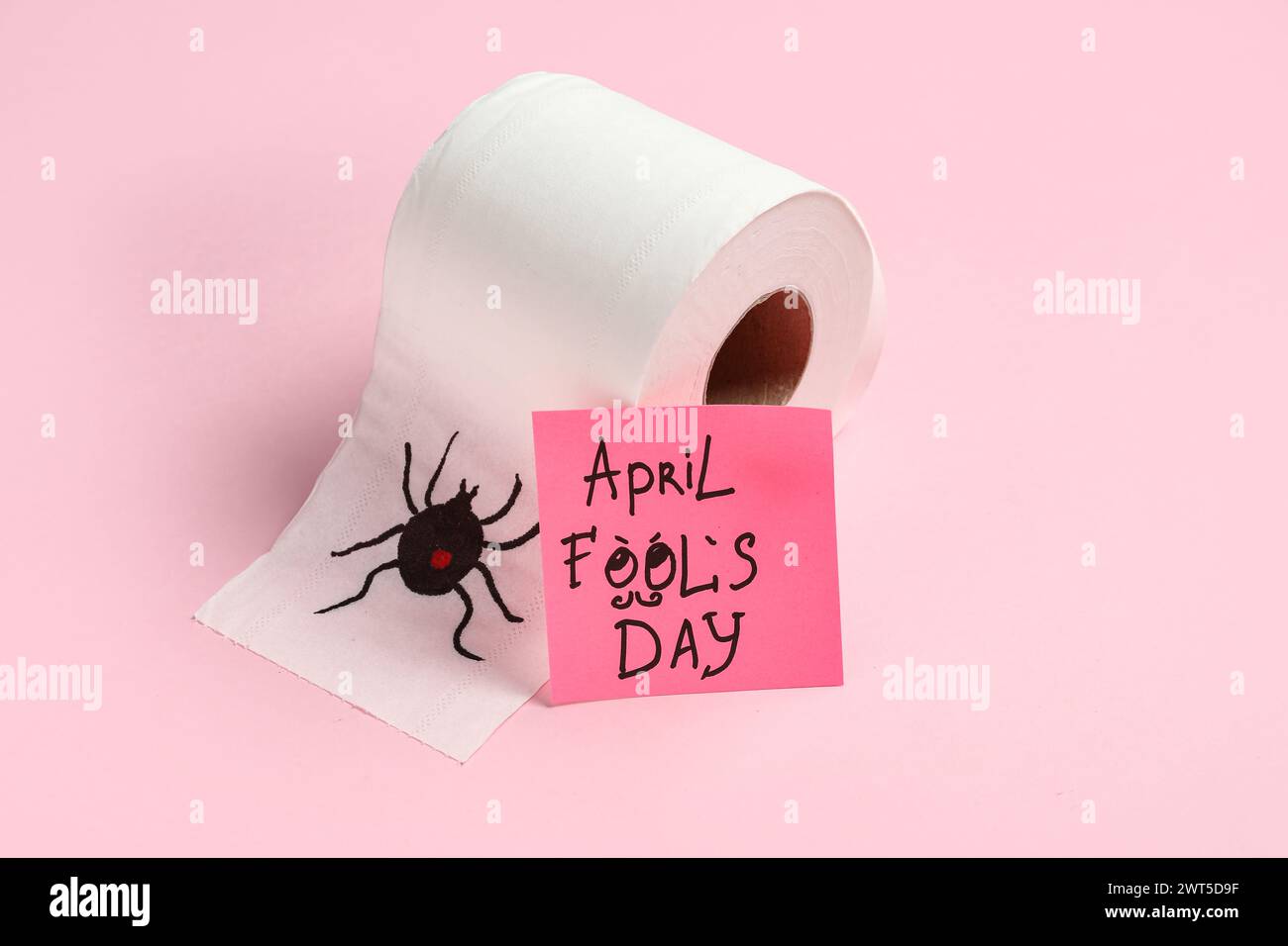 Drawing of spider on toilet paper and sticky note on pink background ...