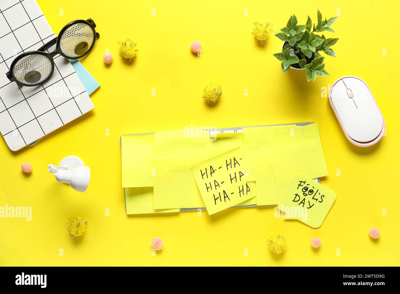 Computer keyboard taped with sticky notes on yellow background. April ...