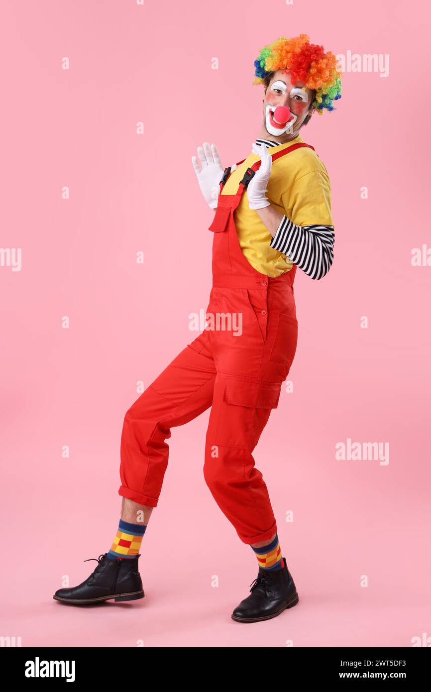Portrait of happy clown on pink background. April Fool's day ...