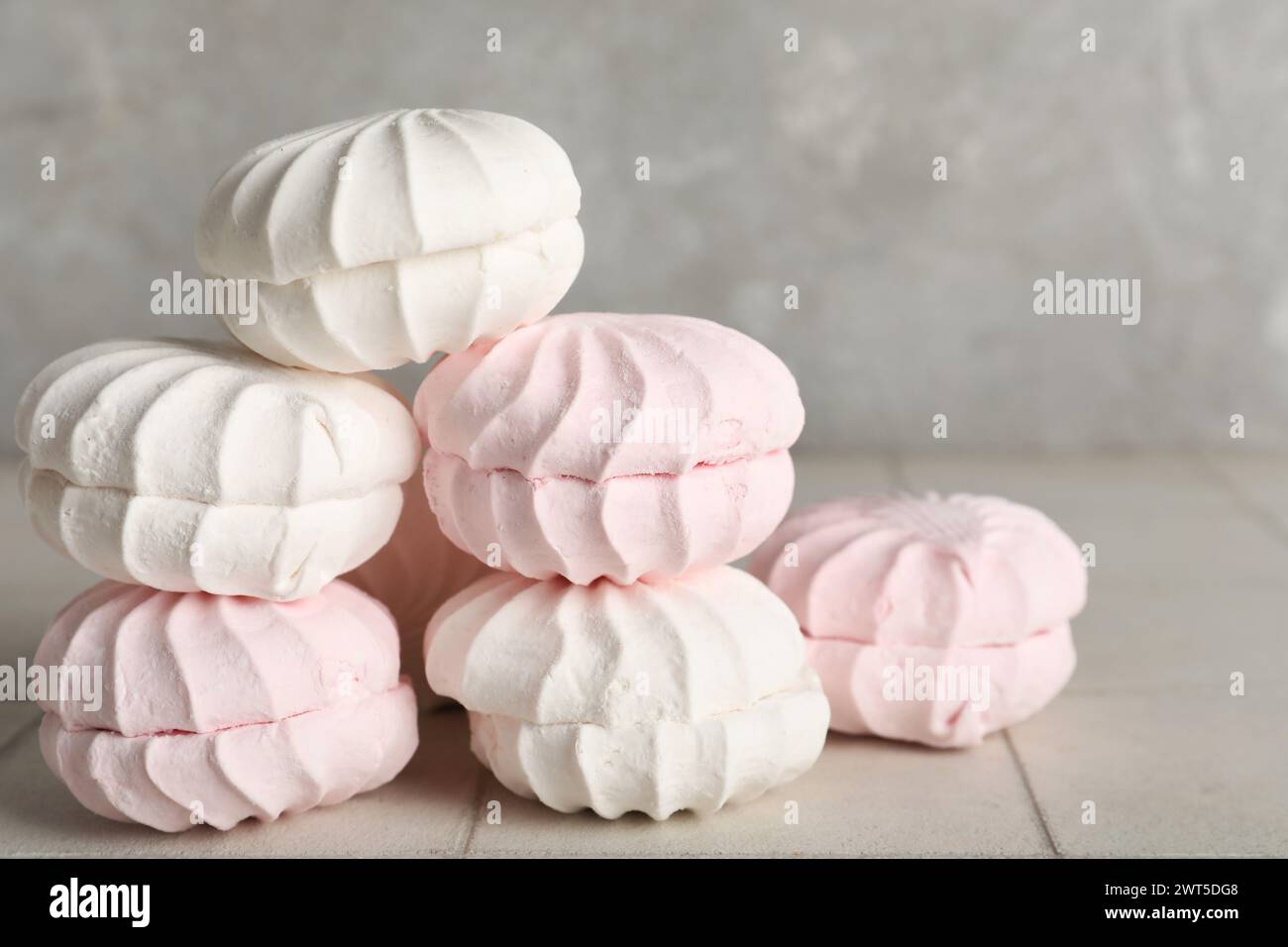 Sweet zefirs on grey background Stock Photo - Alamy