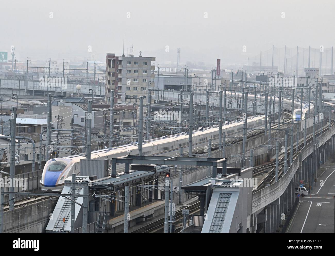 The Hokuriku Shinkansen (L) departs from Tsuruga Station in Tsuruga ...