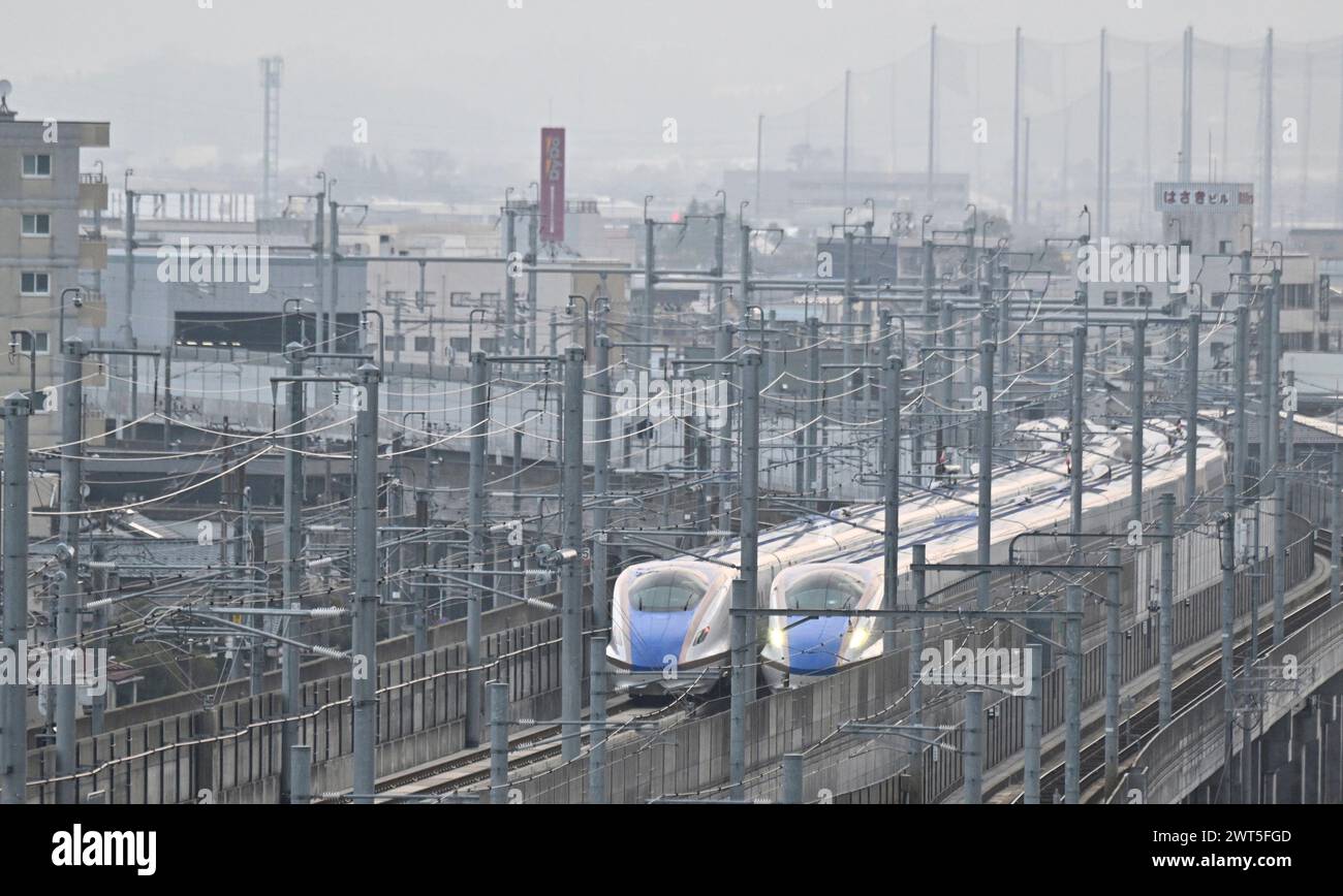 The Hokuriku Shinkansen (L) departs from Tsuruga Station in Tsuruga ...