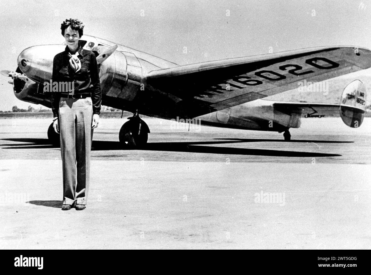 1937: Aviation pioneer AMELIA EARHART stands beside her Lockheed ...