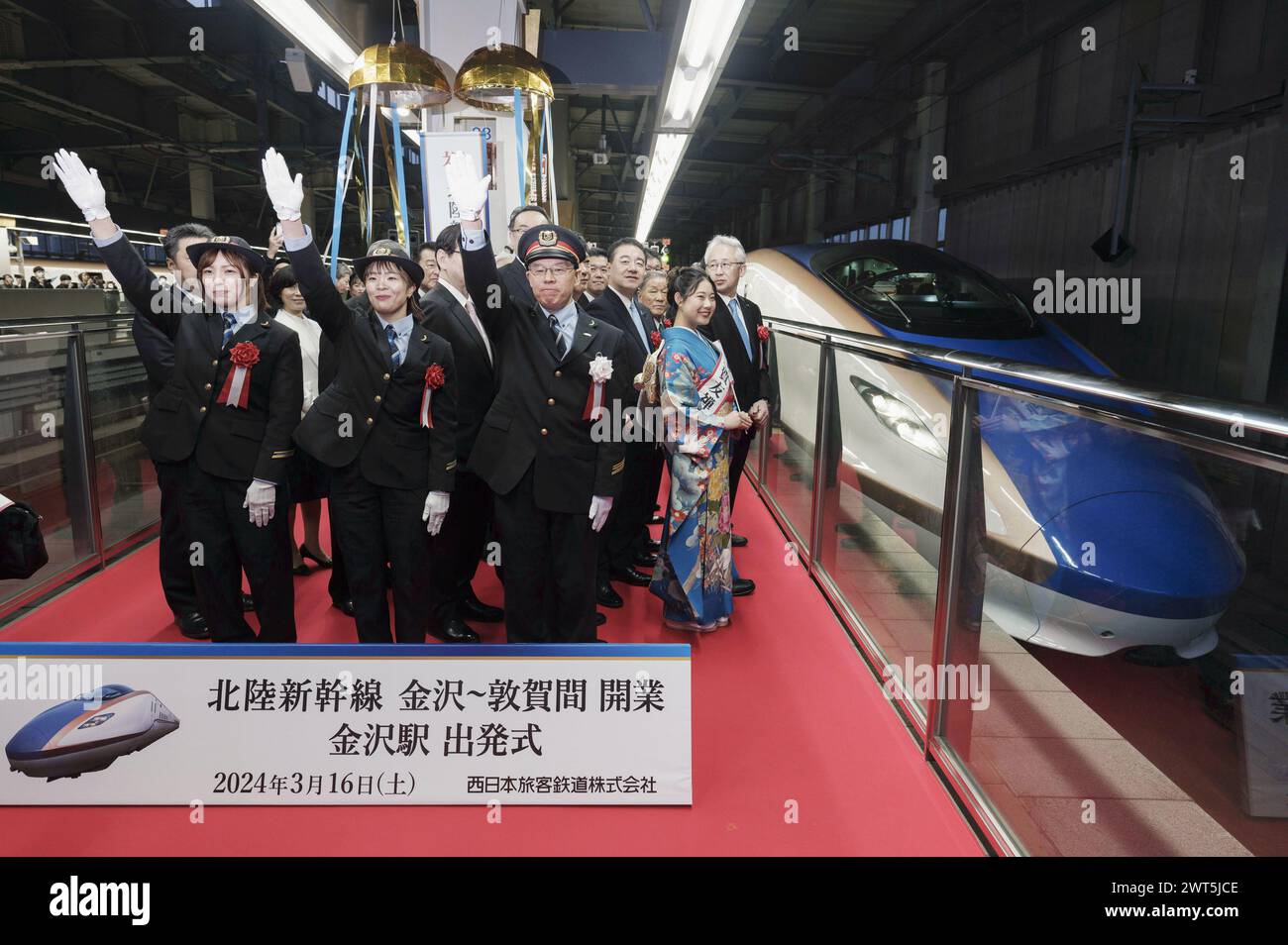 The first train bound for Tsuruga in Fukui Prefecture, central Japan, departs JR Kanazawa ...