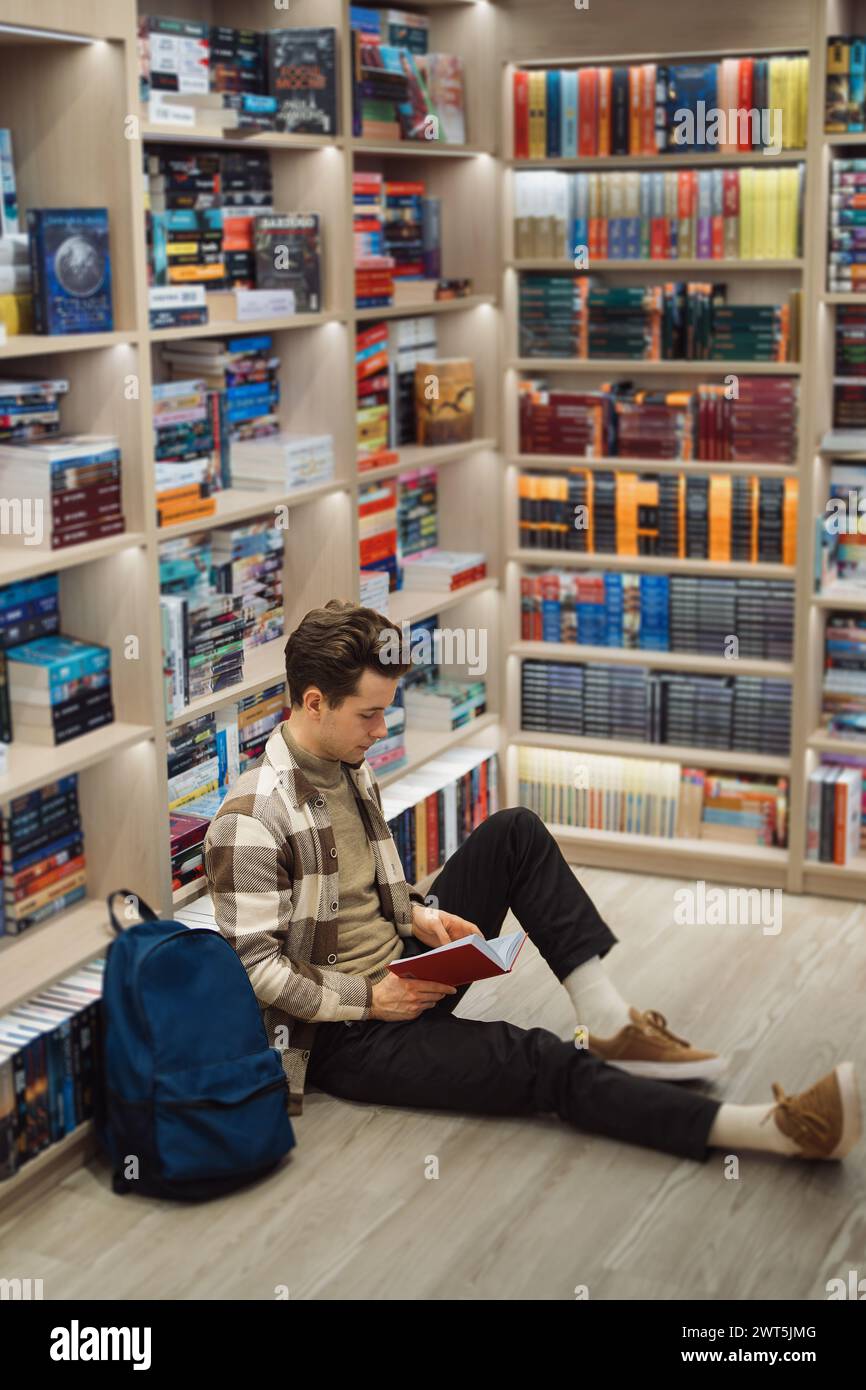 Absorbed man reading book sitting hi-res stock photography and images ...
