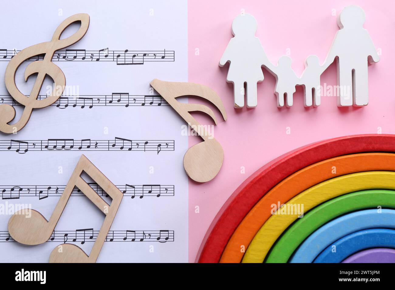 Baby songs. Music sheet, figures of family, wooden notes and toy ...