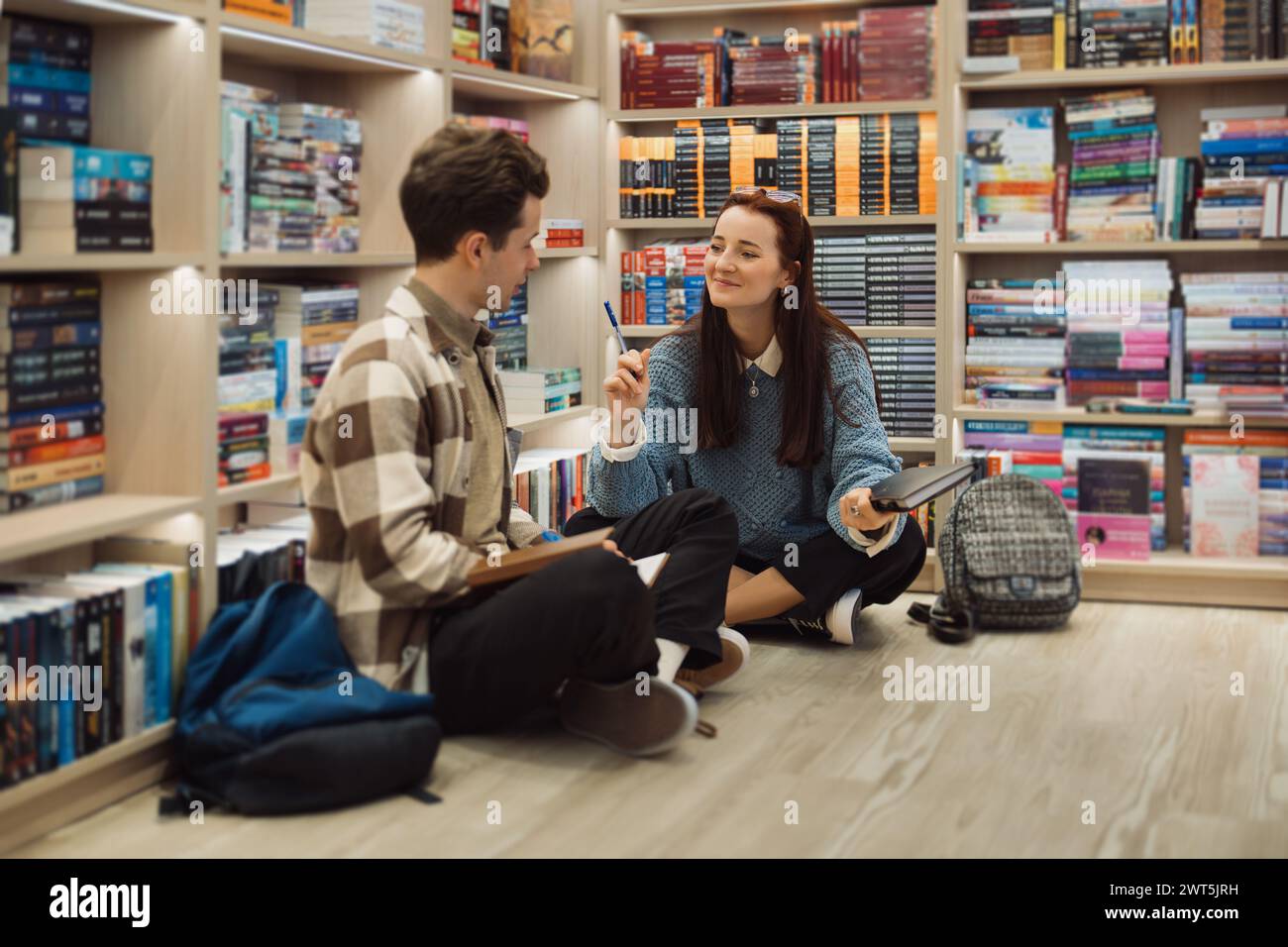 Young students studying together in library bookstore Stock Photo - Alamy