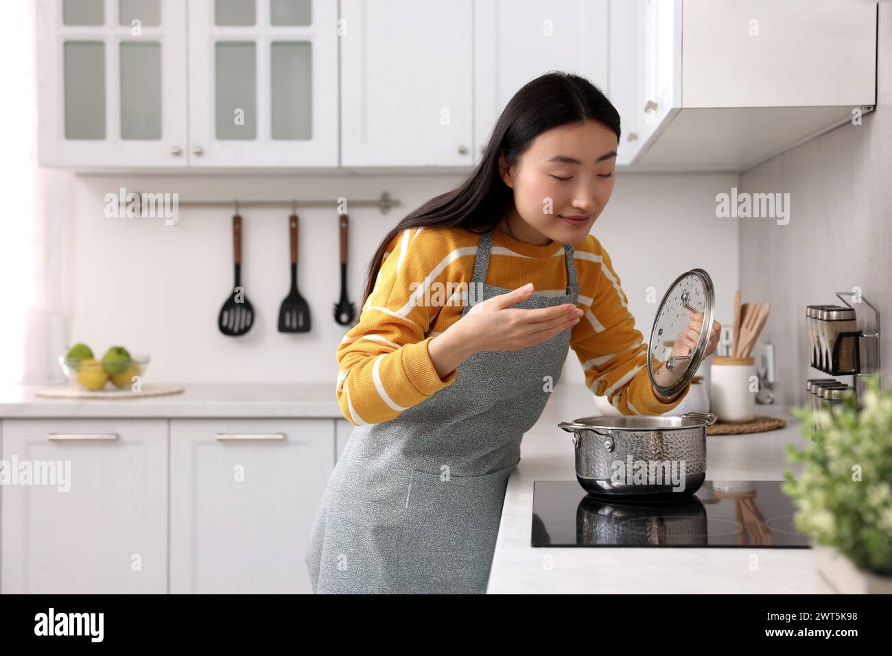 Young woman smelling food cooking hi-res stock photography and images ...