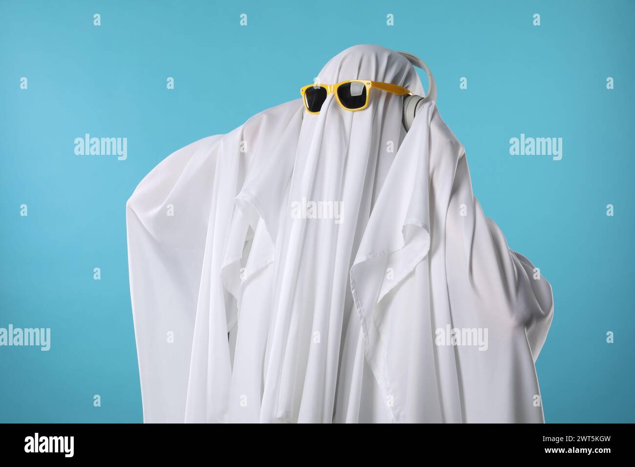 Stylish ghost. Person covered with white sheet in sunglasses and ...