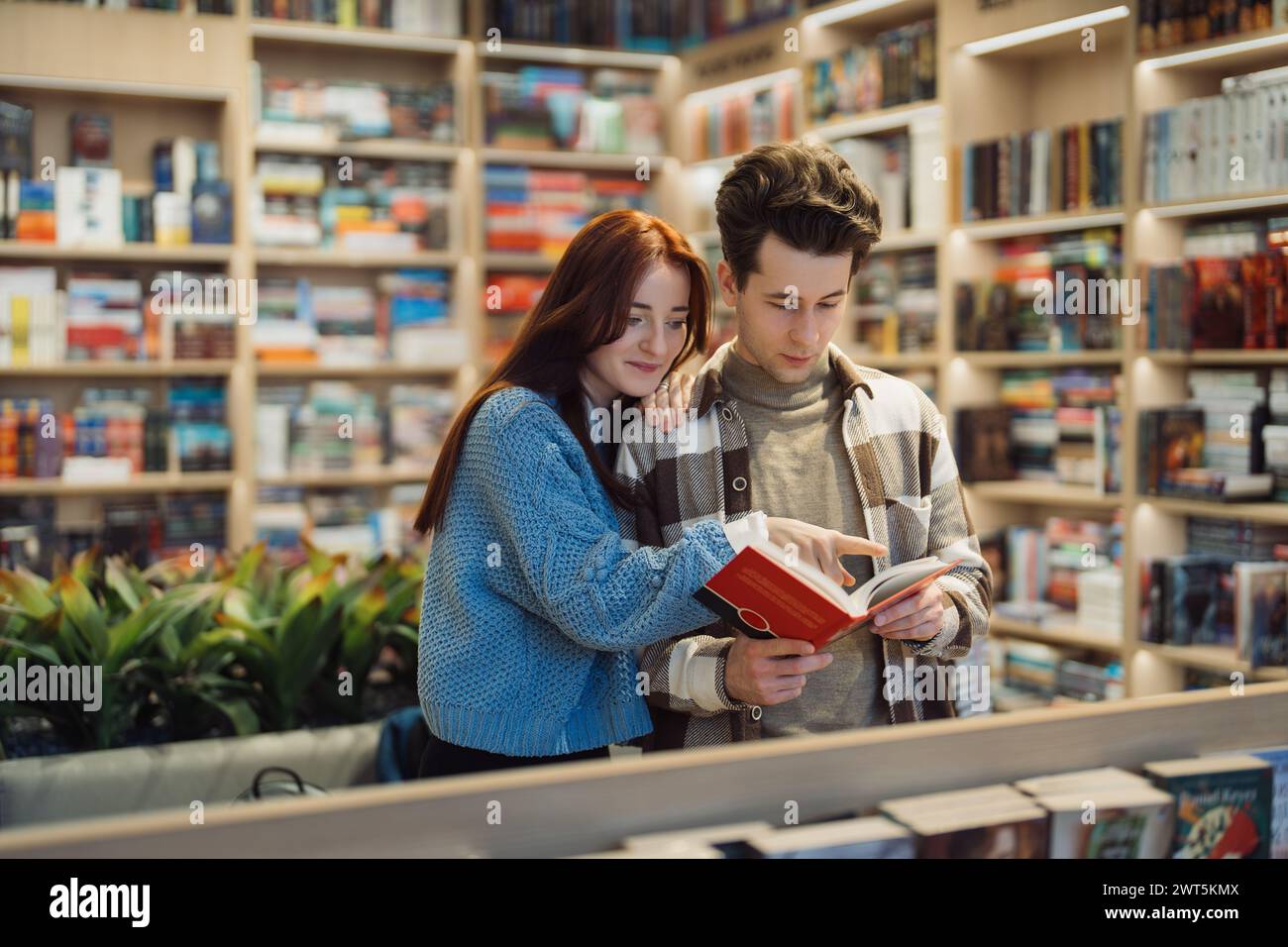 Young couple browsing books together in bookstore Stock Photo - Alamy