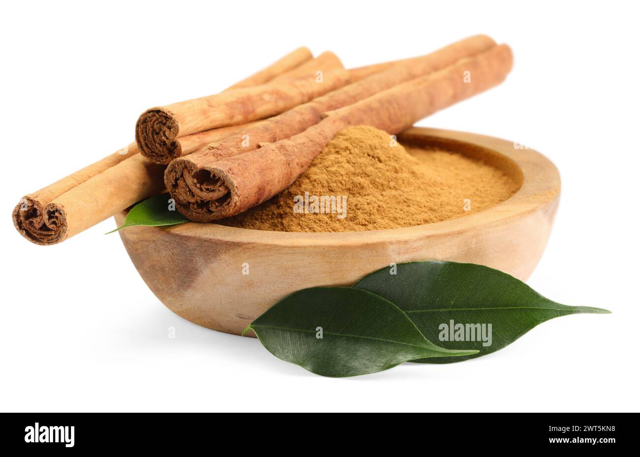 Dry aromatic cinnamon sticks, powder and green leaves isolated on white ...