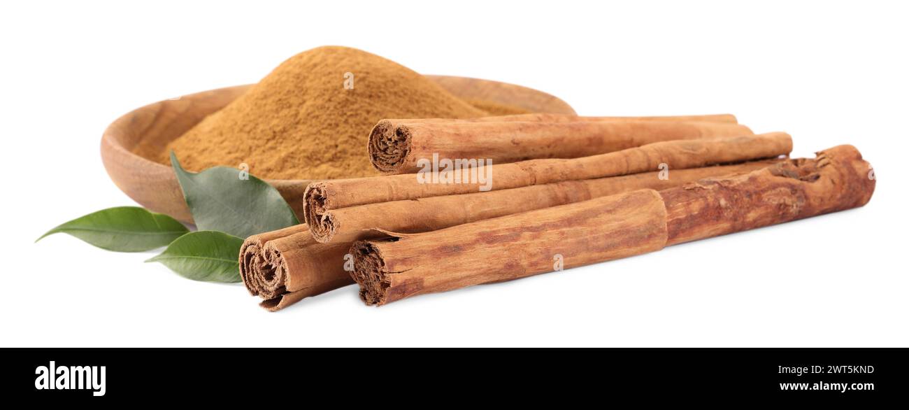 Dry aromatic cinnamon sticks, powder and green leaves isolated on white ...