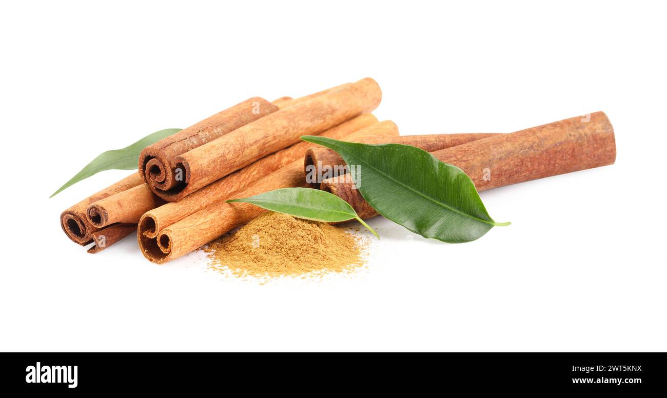 Dry aromatic cinnamon sticks, powder and green leaves isolated on white ...
