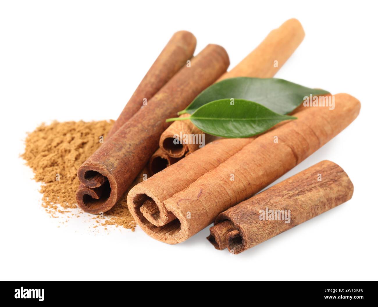 Dry aromatic cinnamon sticks, powder and green leaves isolated on white ...