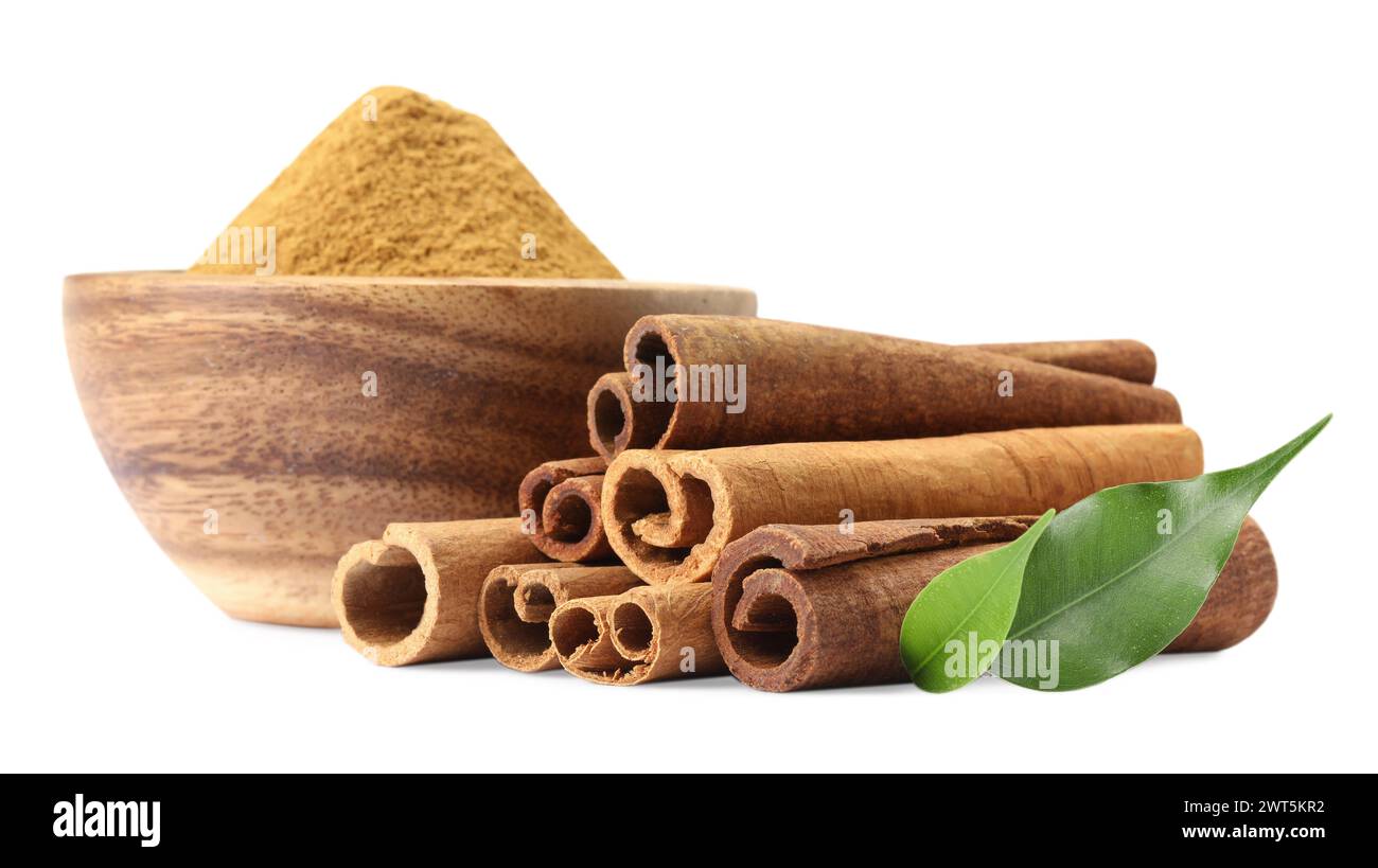 Dry aromatic cinnamon sticks, powder and green leaves isolated on white ...
