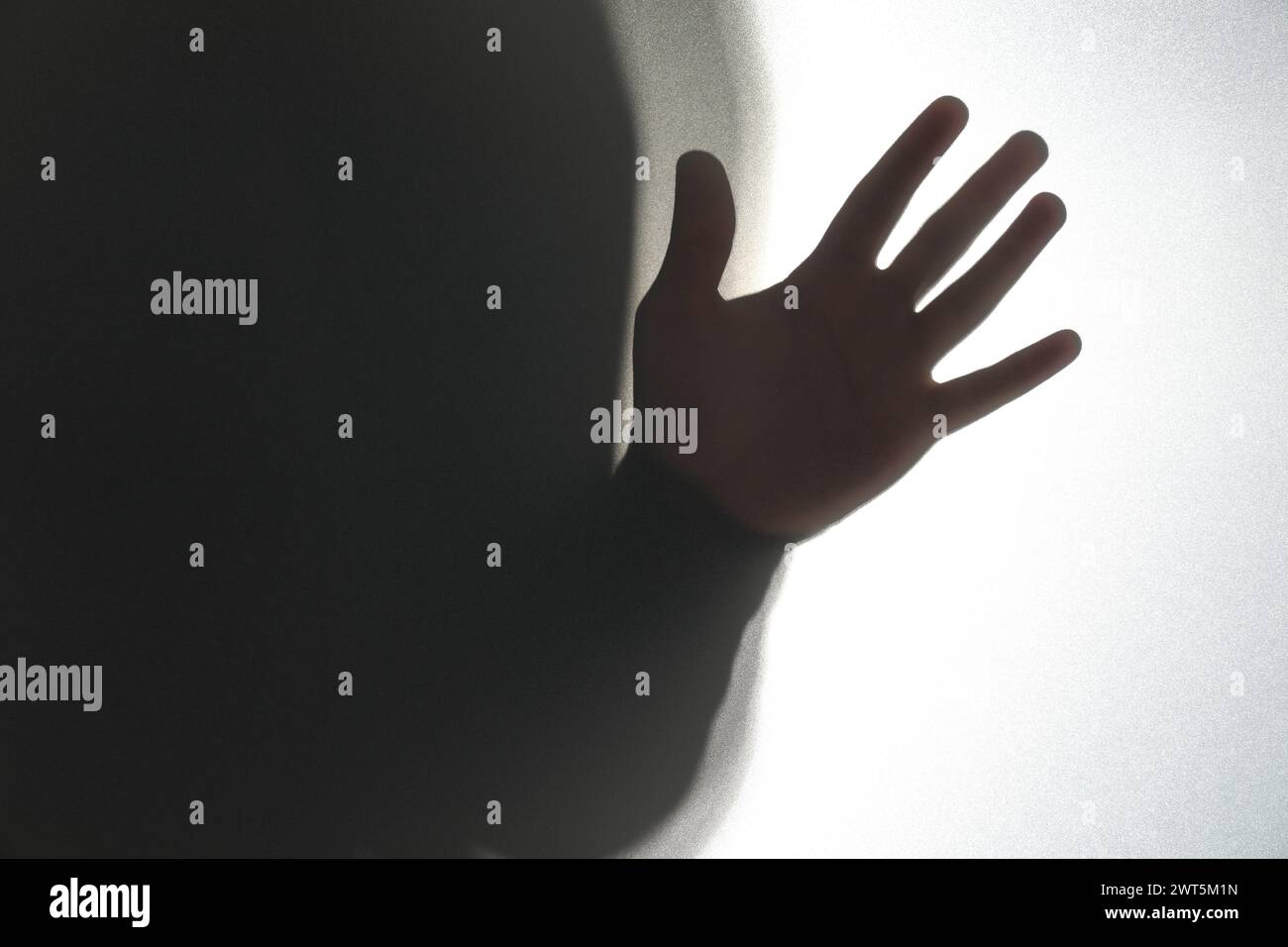 Silhouette of ghost behind glass against white background, closeup ...
