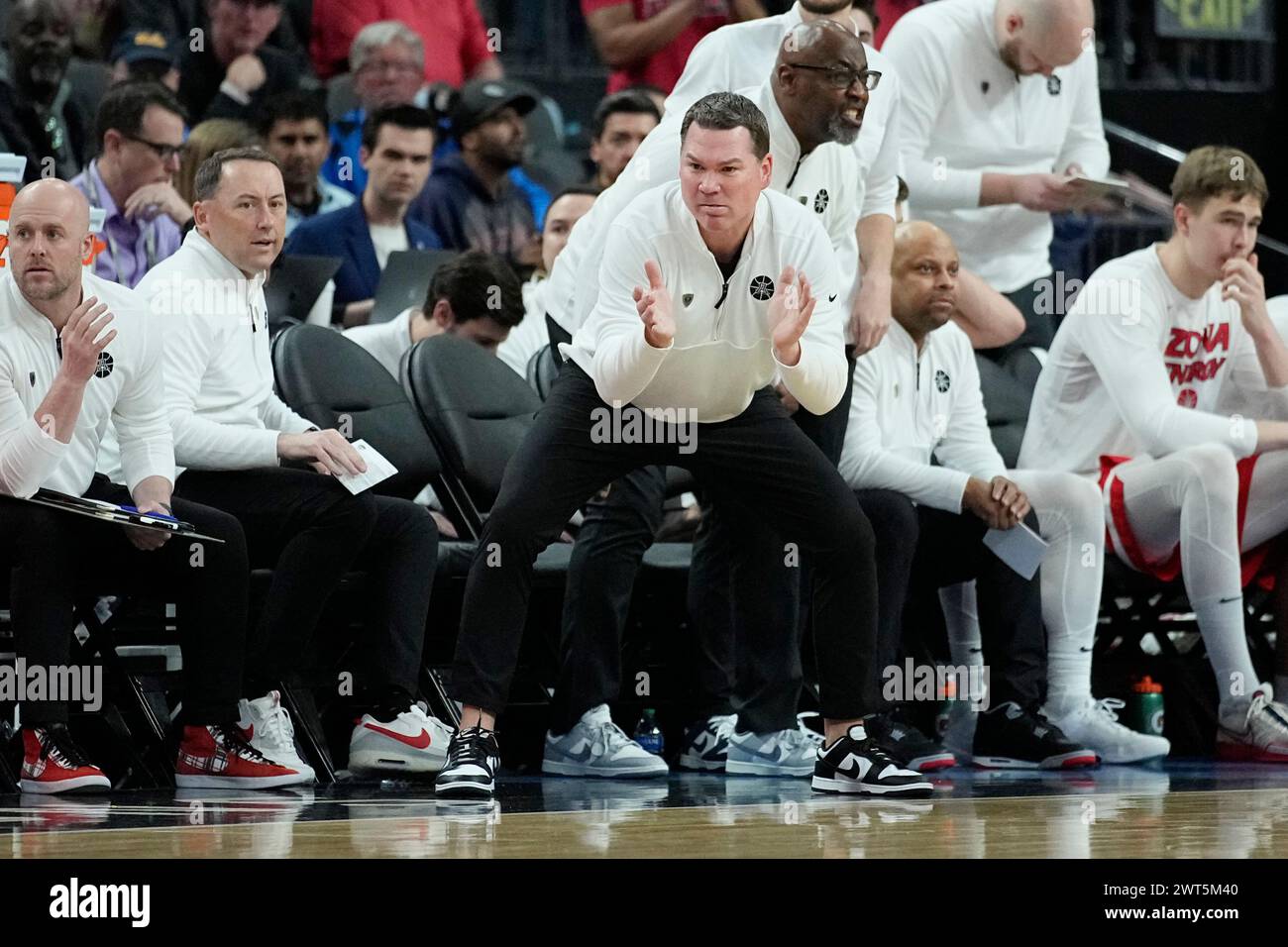 Arizona head coach Tommy Lloyd motions towards the court during the ...