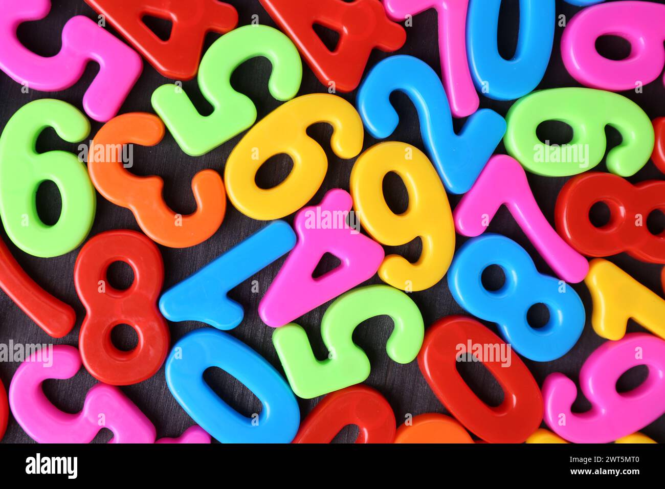 Colorful numbers on dark wooden school desk, top view Stock Photo - Alamy