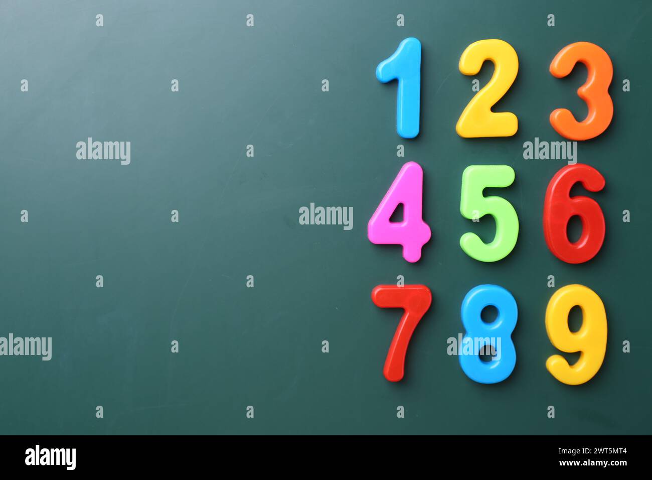 Colorful numbers on green background, flat lay. Space for text Stock ...