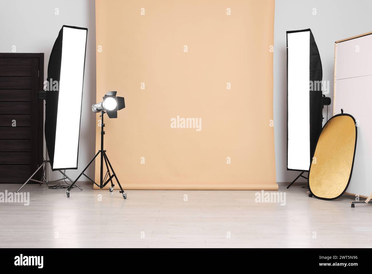 Beige photo background and professional lighting equipment in studio ...