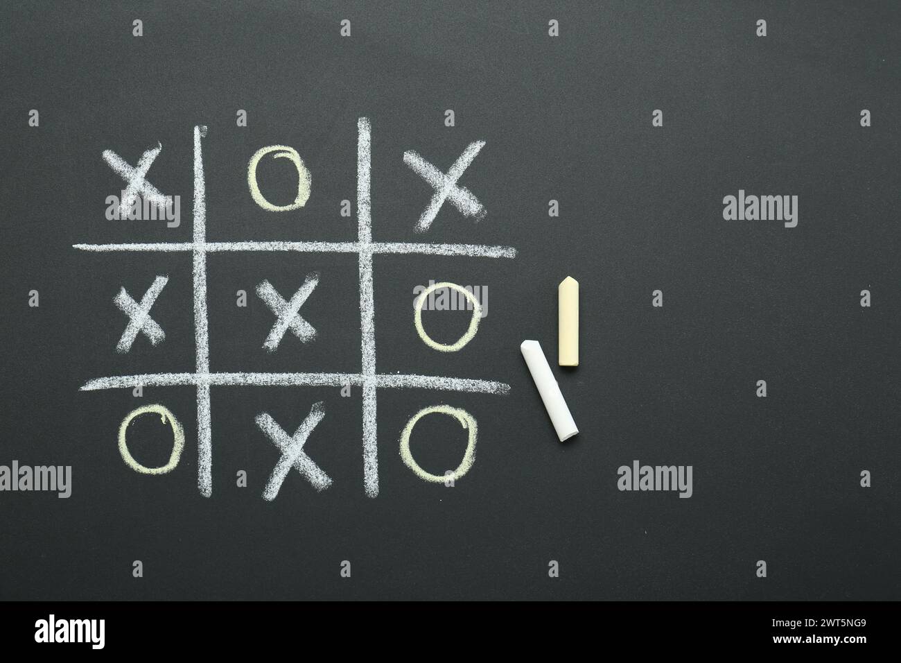 Tic tac toe game drawn on chalkboard, top view Stock Photo - Alamy