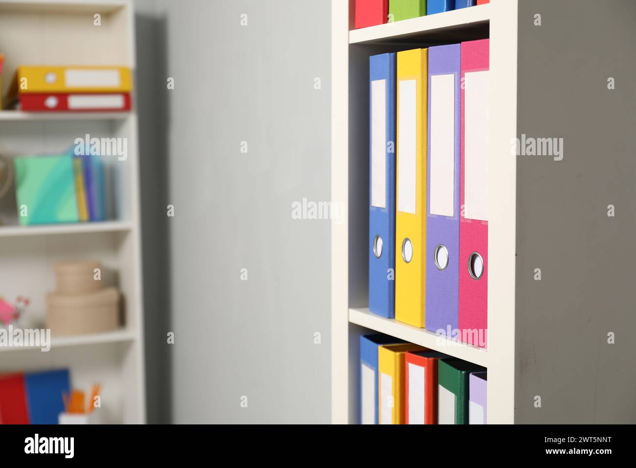 Colorful binder office folders on shelving unit indoors Stock Photo - Alamy