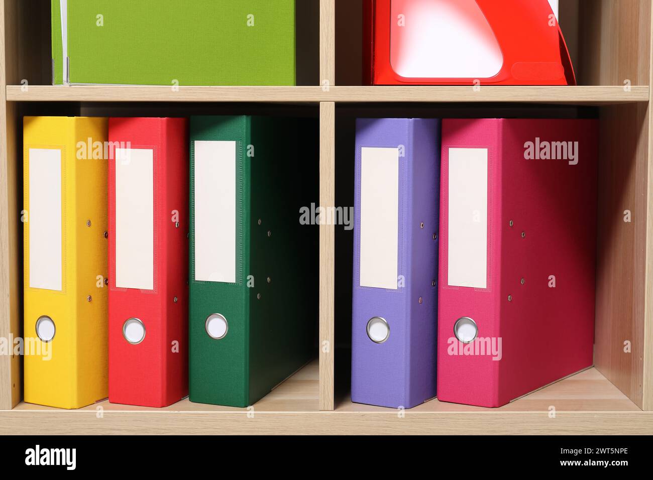 Colorful binder office folders on shelving unit Stock Photo - Alamy