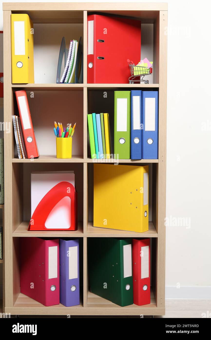 Colorful binder office folders and stationery on shelving unit indoors ...