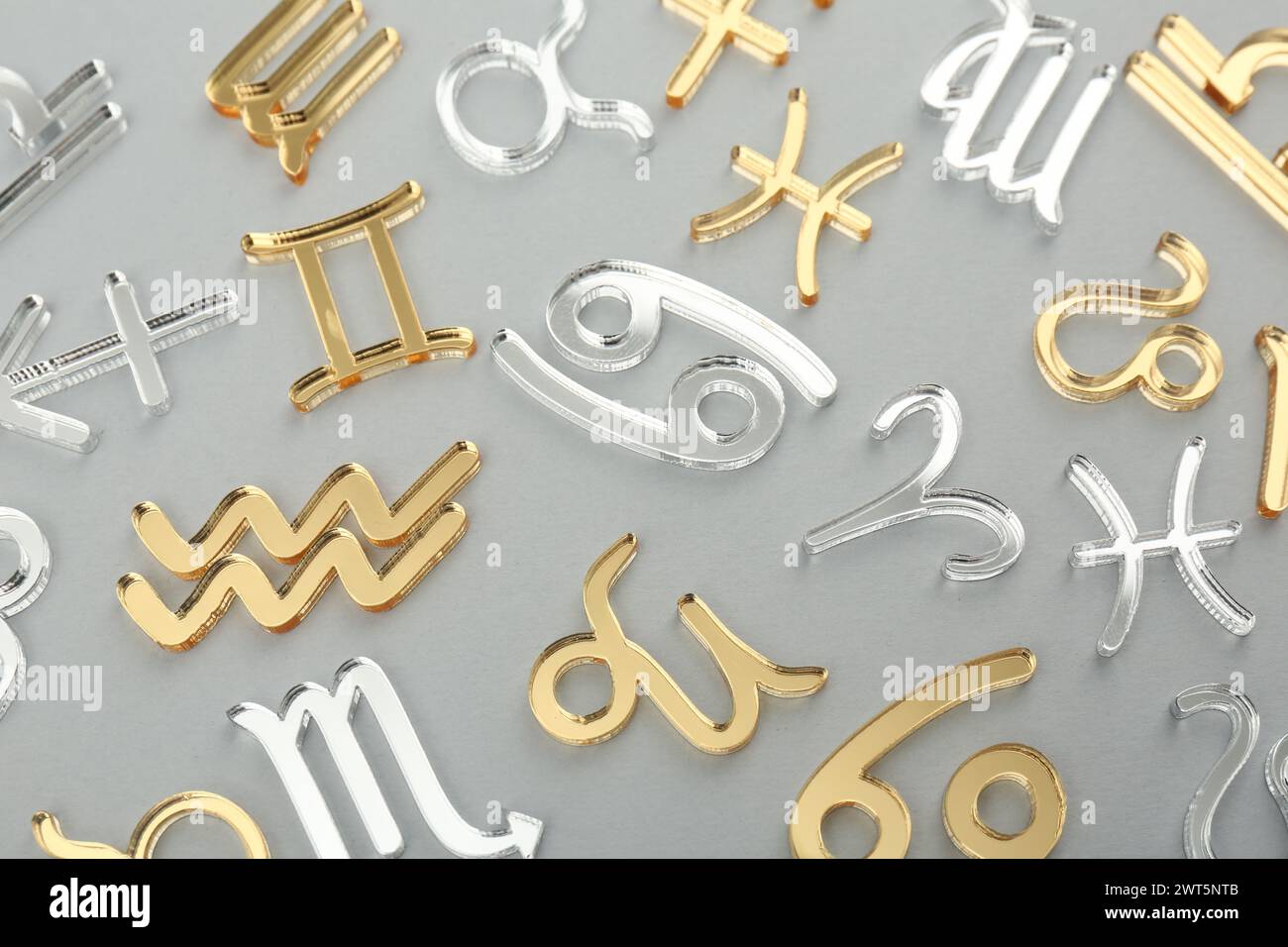 Zodiac signs on grey background, flat lay Stock Photo - Alamy