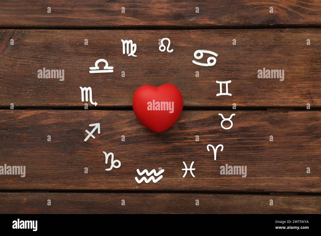 Zodiac signs and red heart on wooden background, flat lay Stock Photo ...