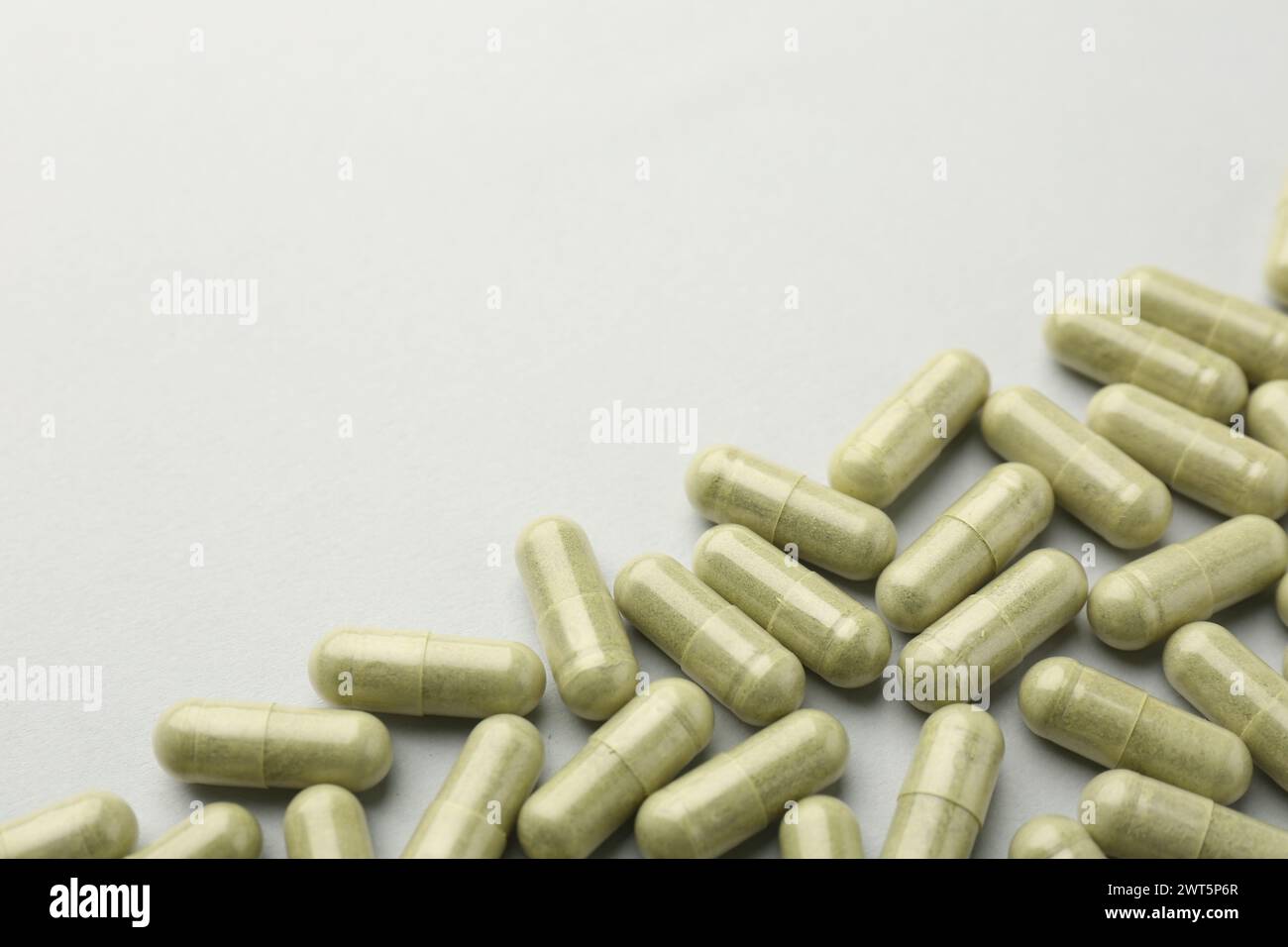 Vitamin capsules on light grey background, above view with space for ...