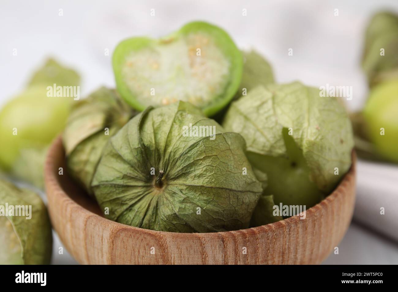 Fresh green tomatillos with husk in bowl on table, closeup Stock Photo ...