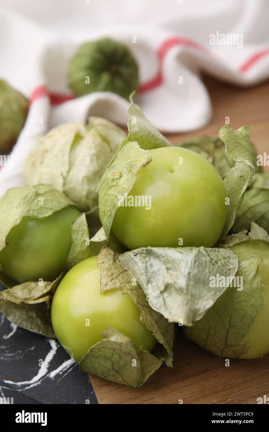 Fresh green tomatillos with husk on table, closeup Stock Photo - Alamy