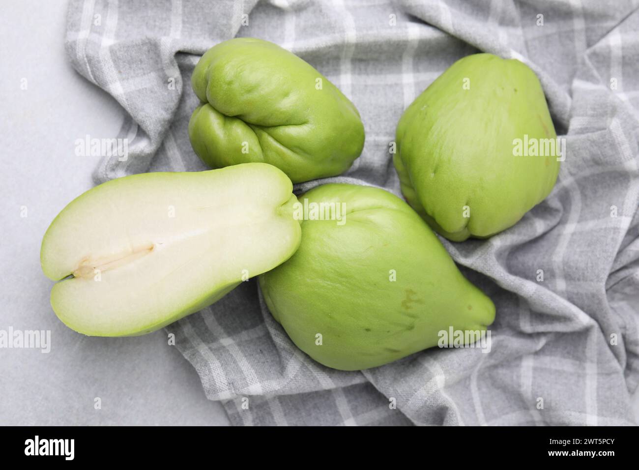 Cut and whole chayote on gray table, top view Stock Photo - Alamy