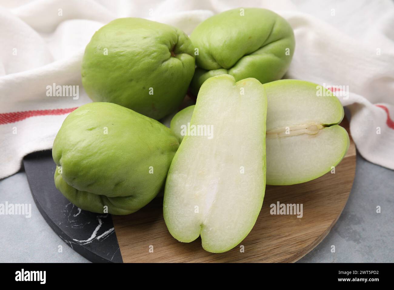 Cut and whole chayote on gray table, closeup Stock Photo - Alamy