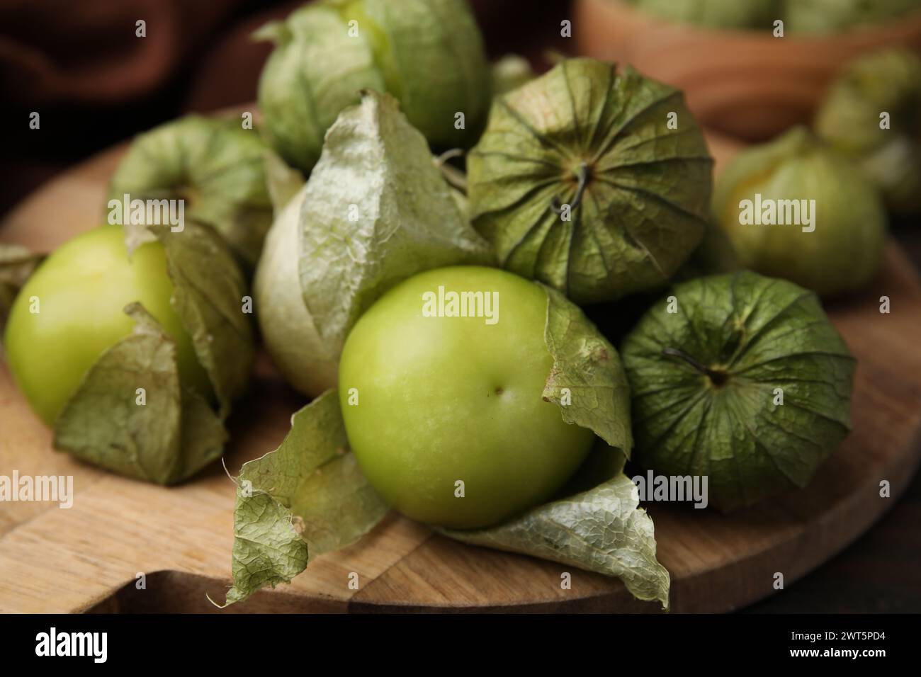 Fresh green tomatillos with husk on table, closeup Stock Photo - Alamy