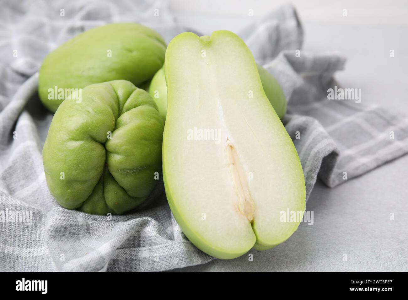 Cut and whole chayote on gray table, closeup Stock Photo - Alamy