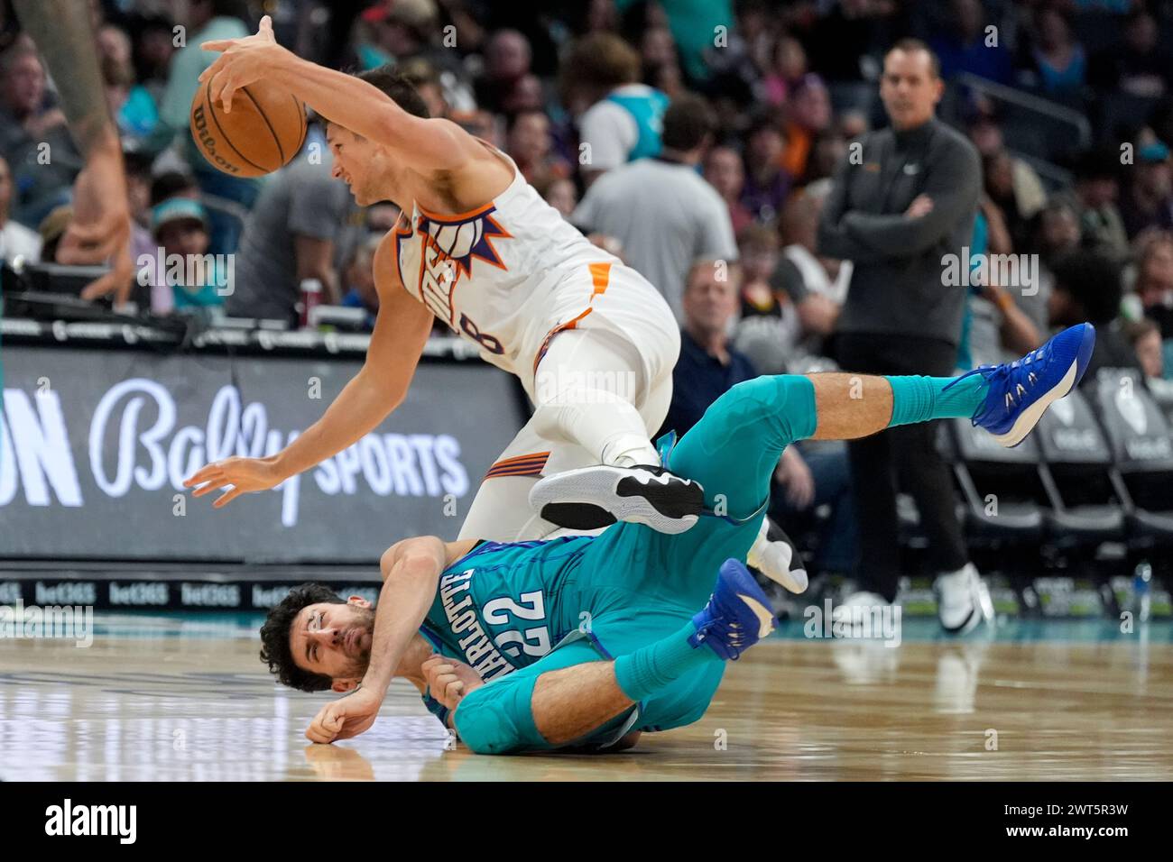 Phoenix Suns guard Grayson Allen, top, and Charlotte Hornets guard Vasa ...