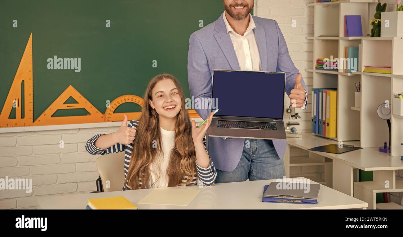 happy student with school teacher presenting laptop screen with copy ...