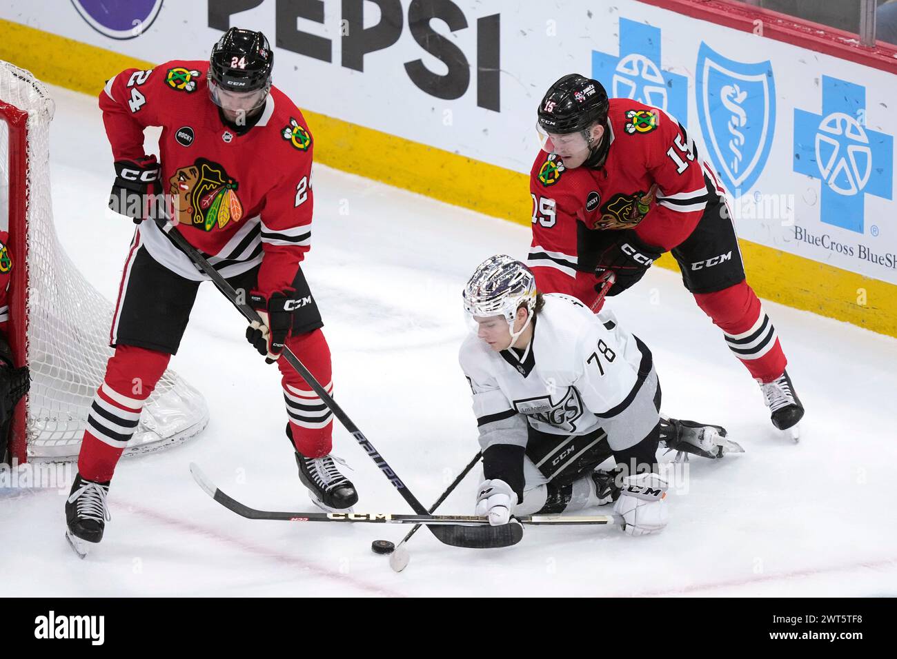 Los Angeles Kings' Alex Laferriere falls to the ice under pressure from ...