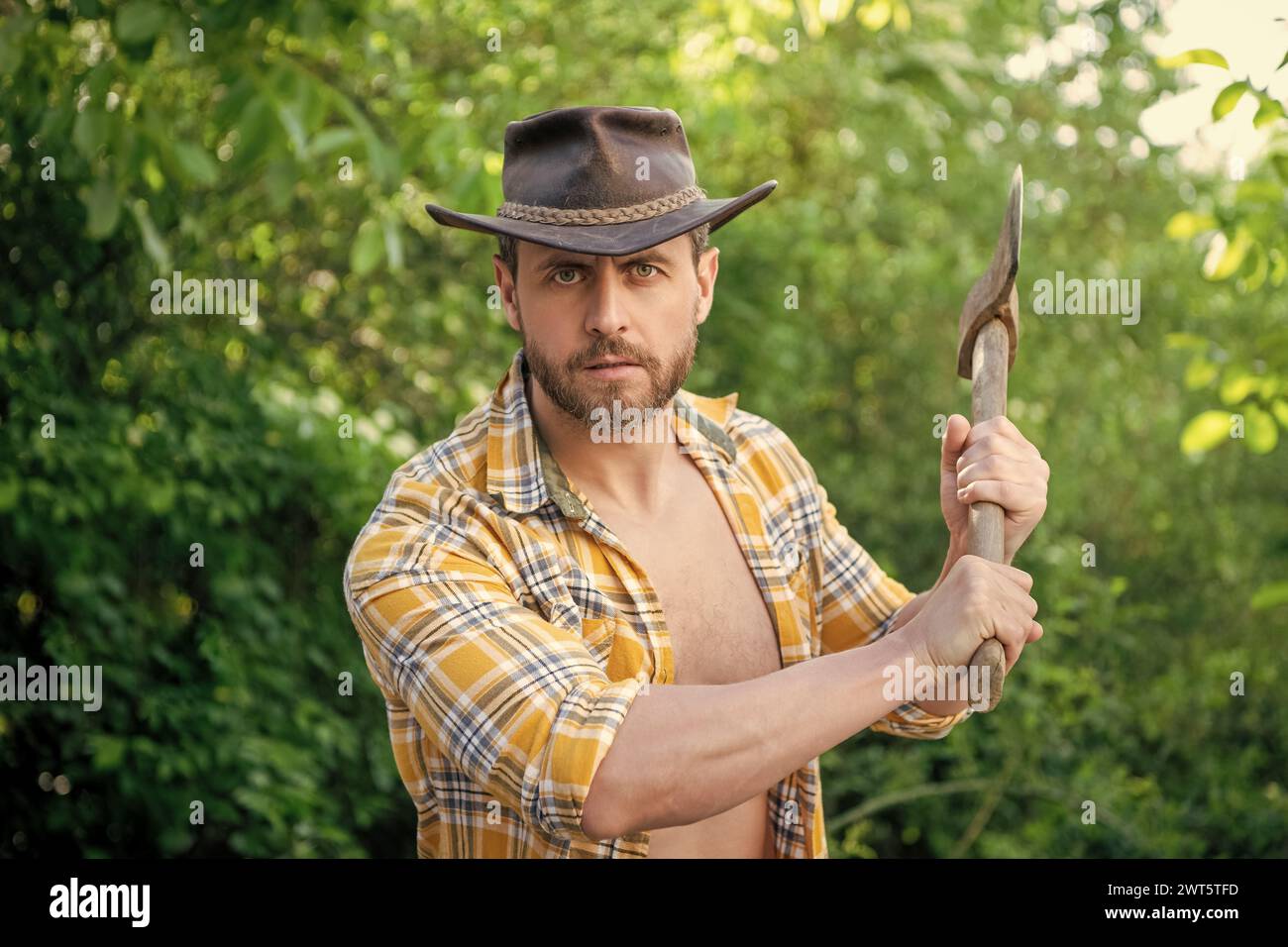 cowboy threaten with axe outdoor. photo of cowboy with axe. cowboy with ...