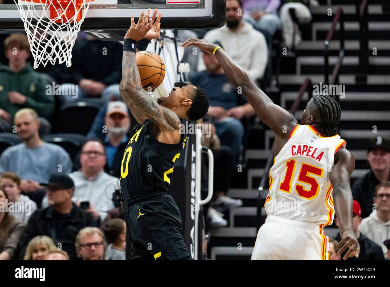 Utah Jazz forward John Collins, left, draws a foul from Atlanta Hawks ...
