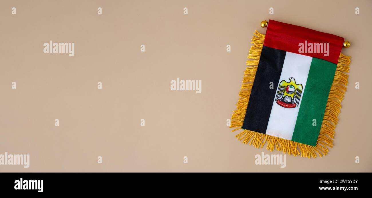 National symbol of UAE. United Arab Emirates small flag with Peregrine ...