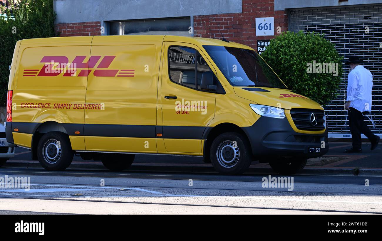 Side view of a DHL delivery van, a Mercedes Benz Sprinter featuring ...