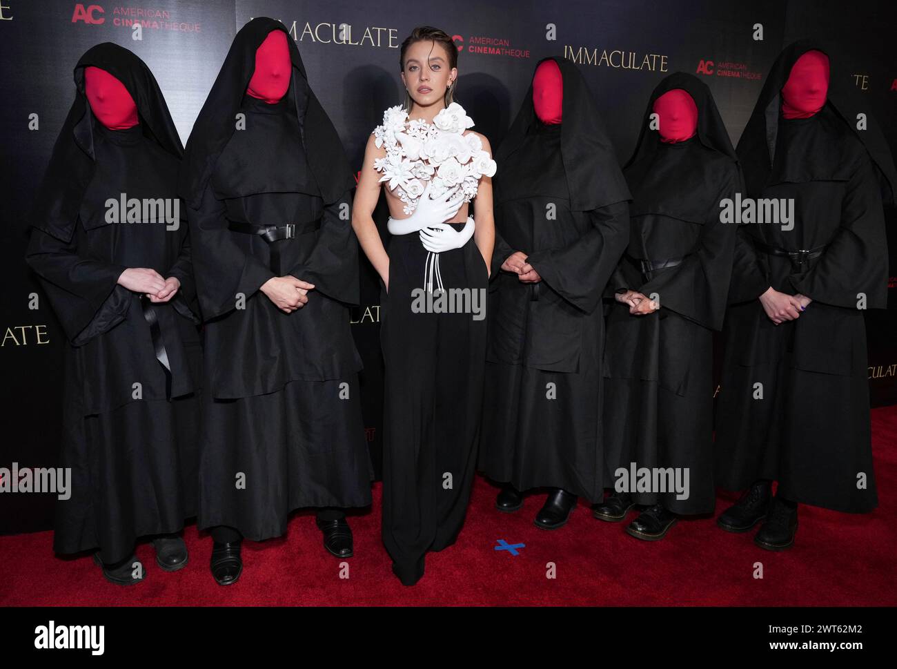 Sydney Sweeney, center, poses with characters from the movie ...