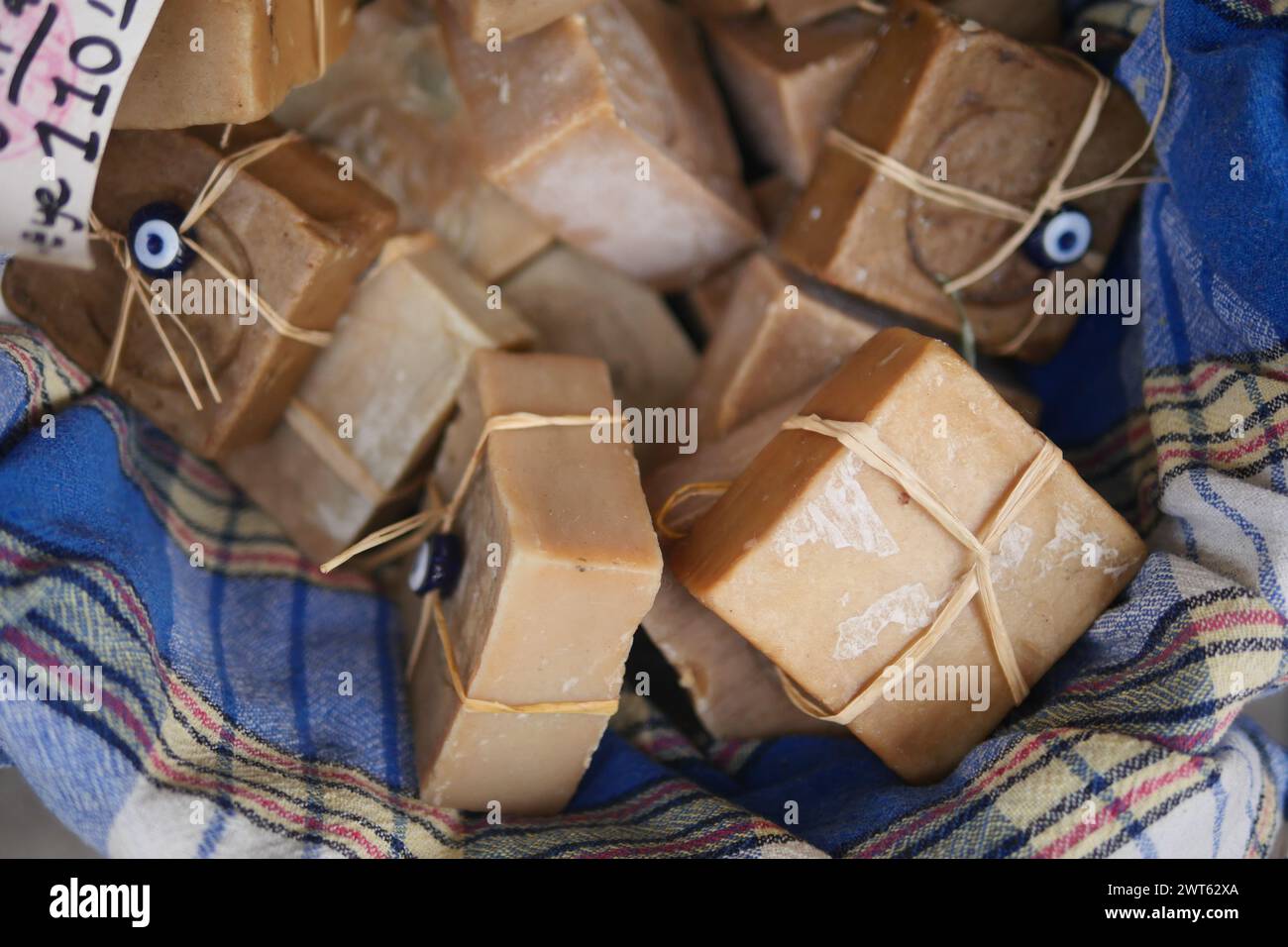 a cloth fabric in a bowl filled with natural soaps Stock Photo - Alamy